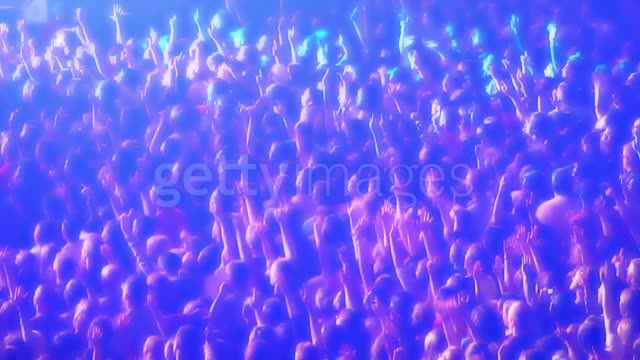 Multi-colored lights flashing across a crowd of cheering fans at a ...