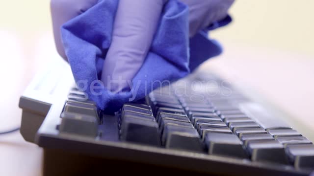 Professional female cleaner wiping pc keyboard and table in office 동영상 ...