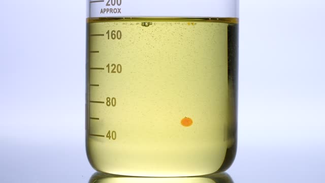 Beutamin - Orange drops falling on beaker containing oil / South Korea ...