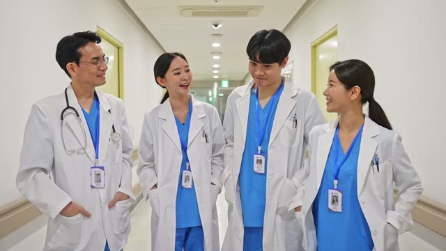 Hospital of Korea - Doctors having conversation and smiling in corridor ...