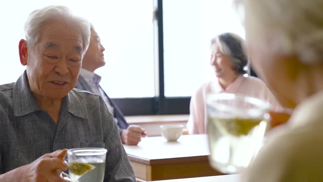 100 year lifespan - Elderly couple having conversation over tea at ...