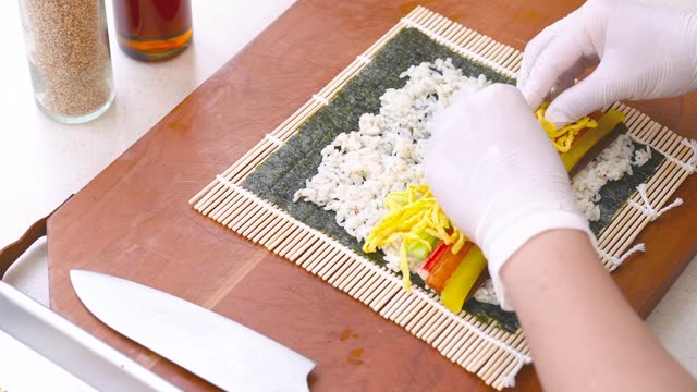 K-food - Cooking Class: Kimbap, placing kimbap ingredients on rice ...