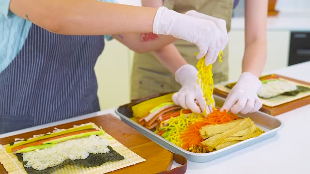 K-food - Cooking Class: Kimbab, foreign women talking while adding ...