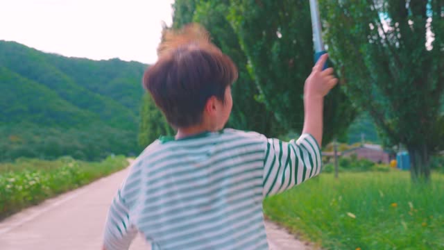 Summer Vacation - Boy running with net on country road in country house ...