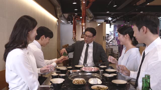 Office dinner at BBQ restaurant : employees nervously drinking after ...