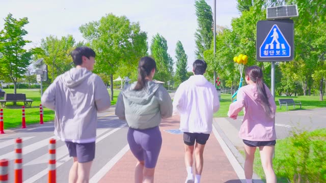 Young running crew man and woman running along Han River / South Korea ...