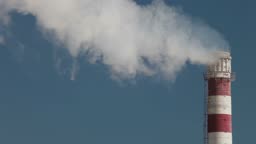 Industrial smokestack with billowing white smoke being pumped into the ...