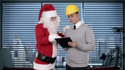 Santa Claus and Young Architect in a modern office 동영상 (VID_2275879 ...