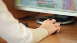 Teen boy playing desktop computer games & focus on the hand with ...