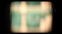 A collection of 8mm and 16mm film strips moving through an open film ...